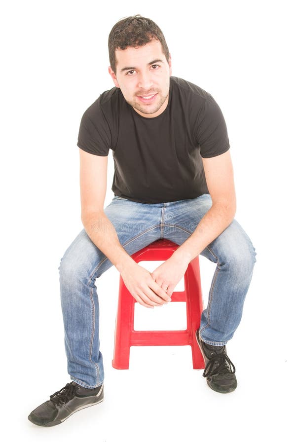 Young Man Sitting on Red Stool Stock Image - Image of confidence ...