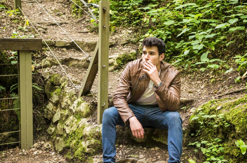 Young Man Sitting and Smoking in Park Stock Image - Image of relax ...