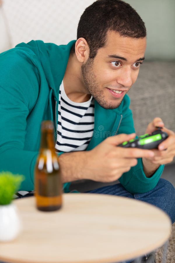 Young Man Sitting on Sofa Playing Computer Game Stock Image - Image of ...