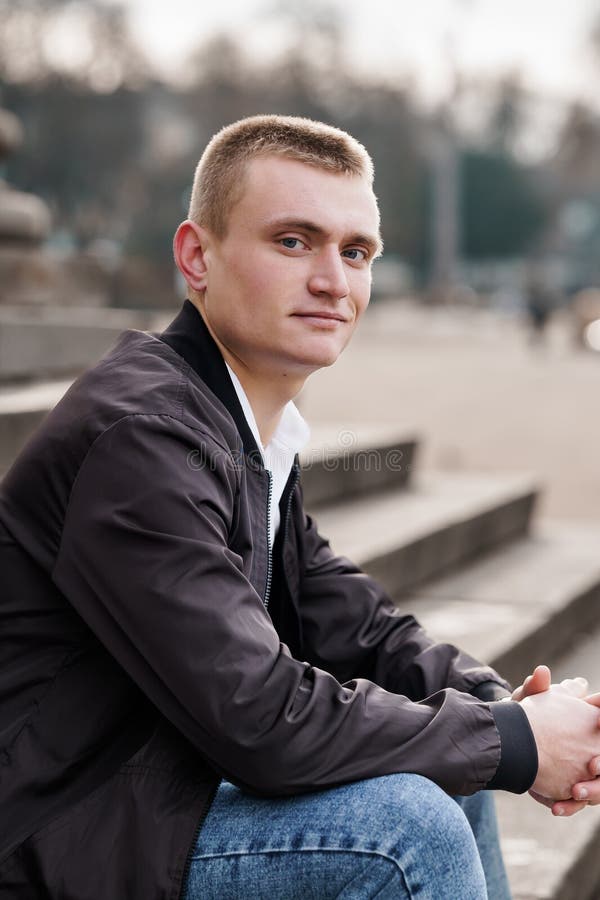 Young Man Sitting on Steps in Urban Environment Stock Image - Image of ...