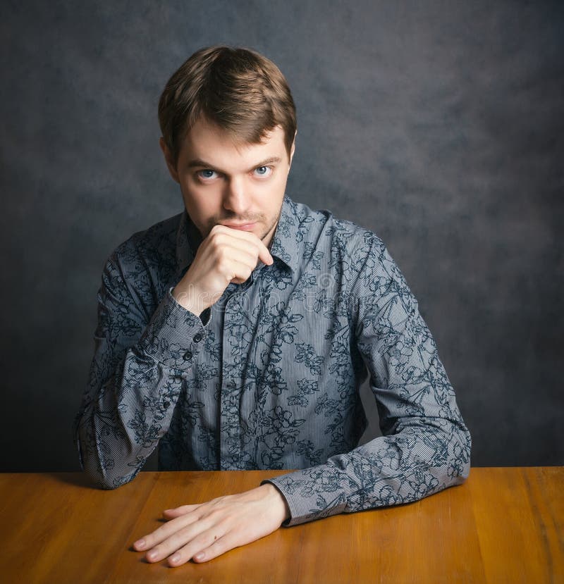 Young Man Sitting at a Table. Stock Photo - Image of camera ...