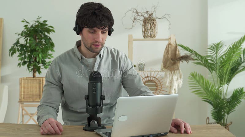 Young Man Sitting at Table with Laptop Talking on Mic Stock Image ...
