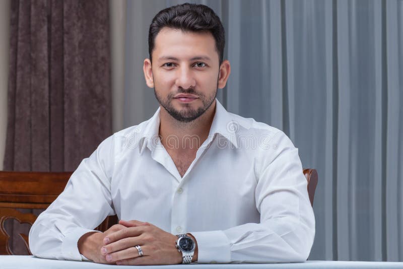 Young man sitting at table stock photo. Image of businessman - 67208608