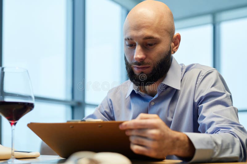 Man Reading Menu in the Restaurant Stock Photo - Image of table, dinner ...