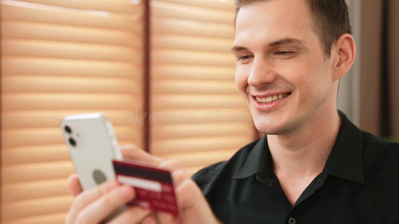 Young Man Sitting at Table Using Online Payment App. Adit Stock Footage ... Young Man Sitting at Table Using Online Payment App. Adit Stock Footage ...