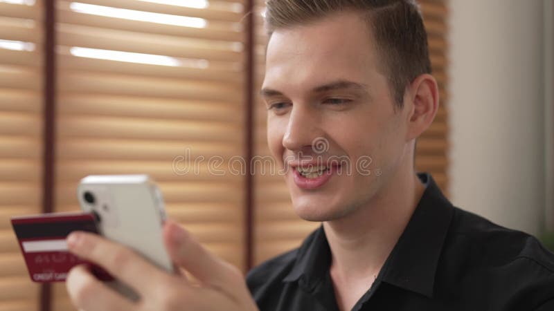 Young Man Sitting at Table Using Online Payment App. Adit Stock Footage ... Young Man Sitting at Table Using Online Payment App. Adit Stock Footage ...