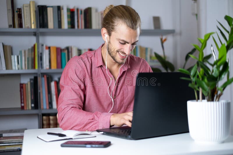Young Man Sitting at the Table Working at Home Stock Photo - Image of ...