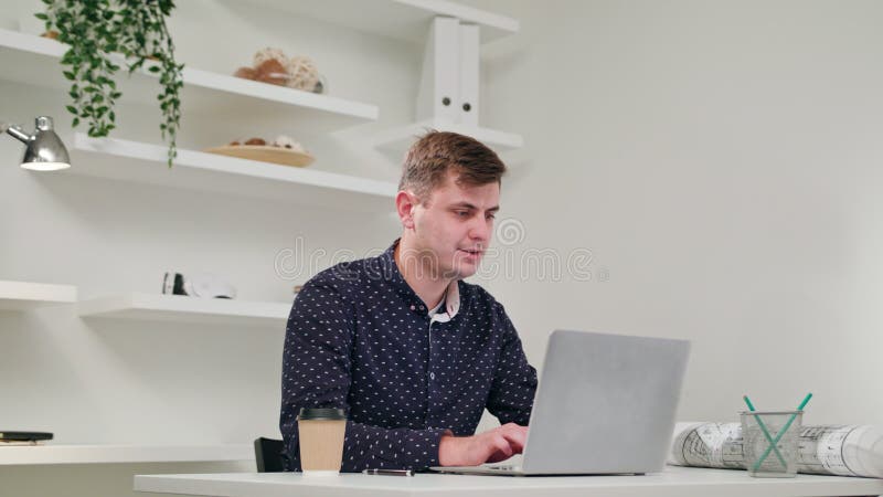 A Young Man Using a Computer Indoors Stock Photo - Image of casual ...
