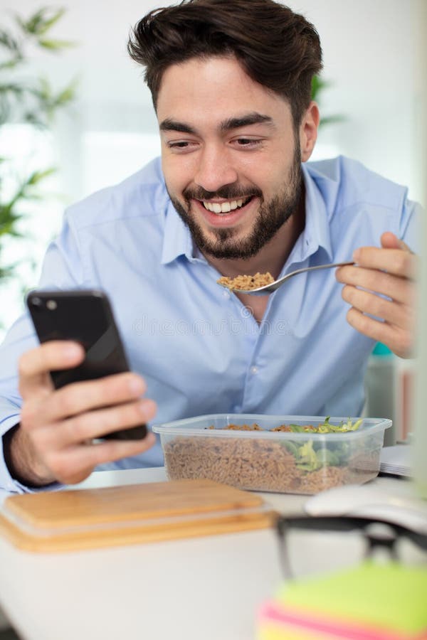 Young Man Sitting Using Phone at Lunch Time Stock Photo - Image of ...
