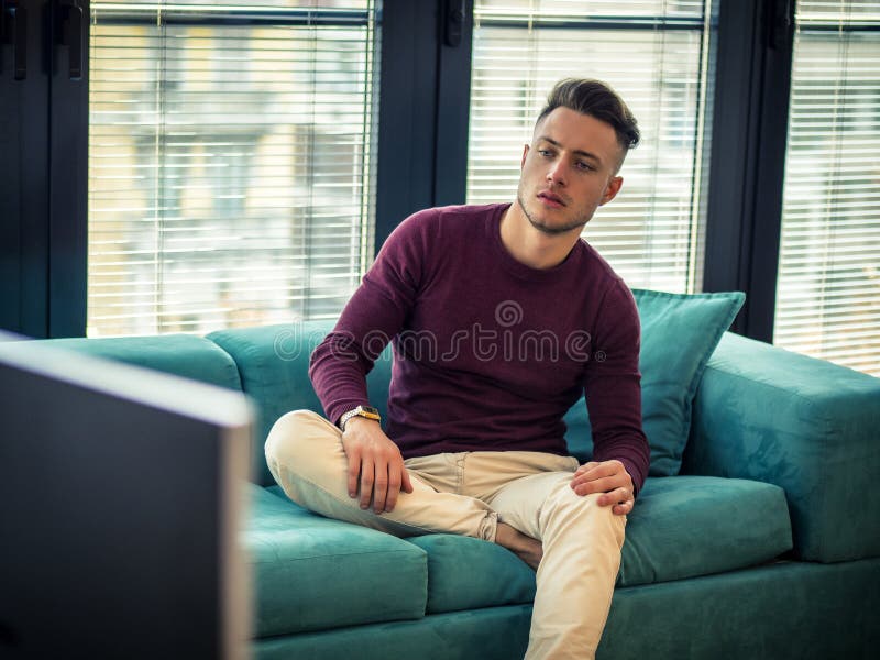 Handsome Young Man on Counch, Using TV Remote Control Stock Image ...