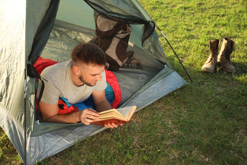 Young Man in Sleeping Bag Lying Inside Camping Tent Stock Photo - Image ...