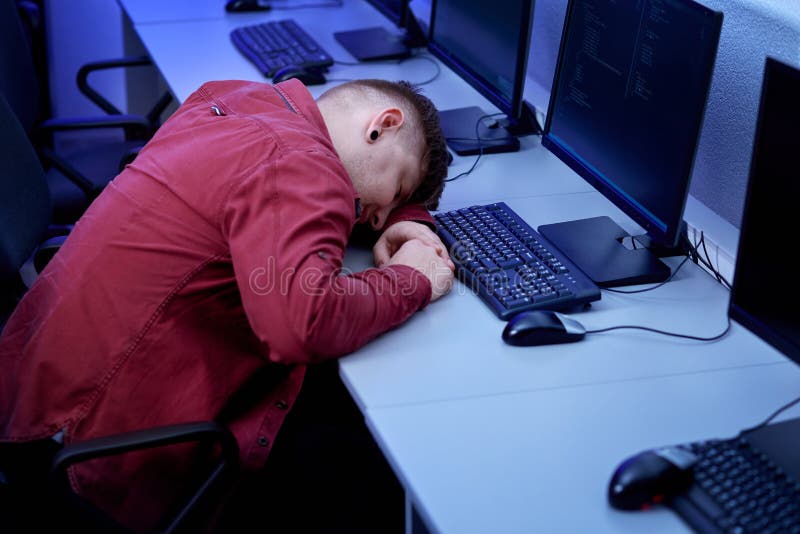 A Young Man is Sleeping at a Computer Desk. Tired after a Long Day at ...