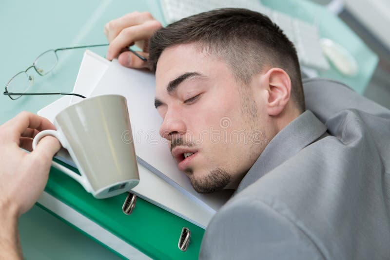 Young man sleeping at desk stock image. Image of insomnia - 102666549