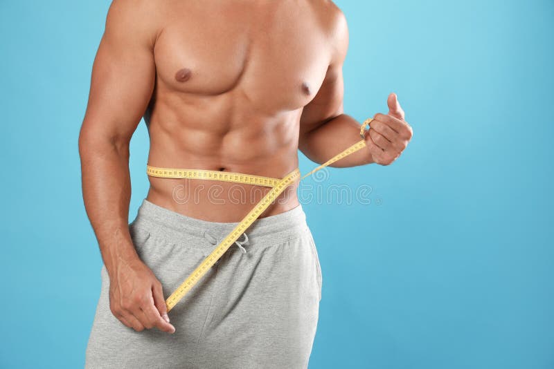 Young Man with Slim Body Using Measuring Tape on Light Blue Background ...