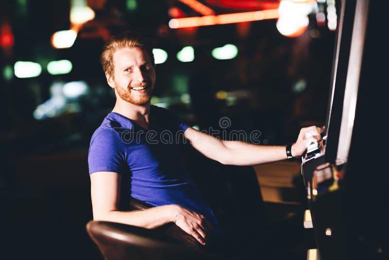 Young Man with Slot Machine in the Casino Stock Photo - Image of chance ...