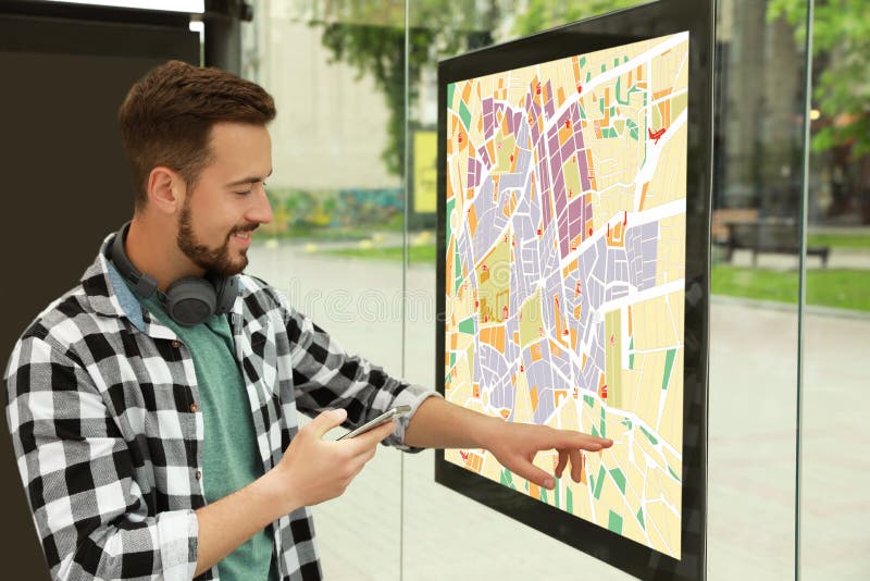 Young Man with Smartphone Near Public Transport Map at Bus Stop Stock ...