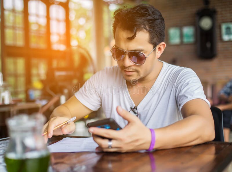 Young Man with Smartphone Smiling Relaxing at Cafe Stock Photo - Image ...