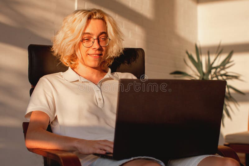 Smiling Guy is Browsing at His Laptop at Home Stock Photo - Image of ...