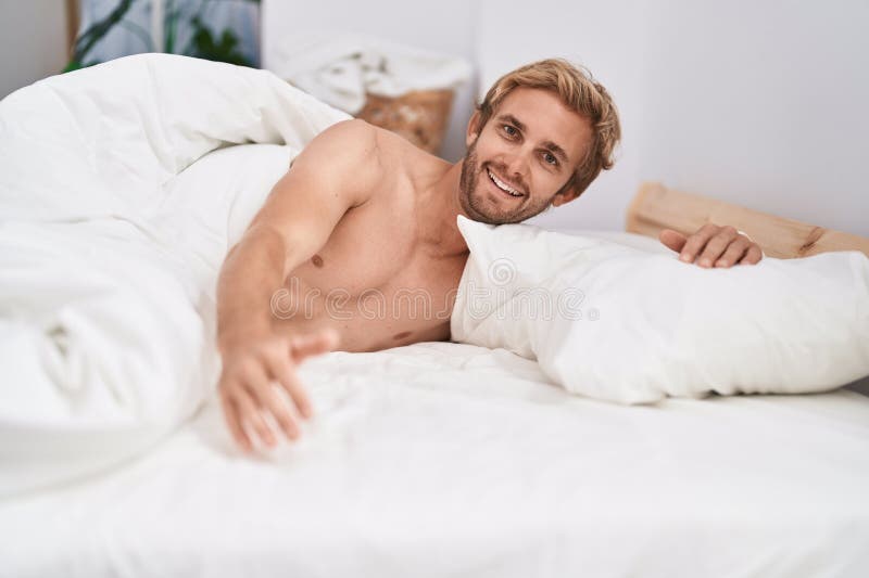 Young Man Smiling Confident Lying on Bed at Bedroom Stock Photo - Image ...