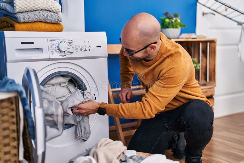 Young Man Smiling Confident Washing Clothes at Laundry Room Stock Image ...