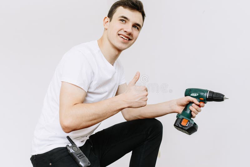 Young Man Smiling with the Drill or Screwdriver Isolated on White ...