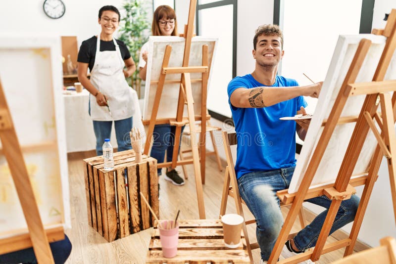 Young Man Smiling Happy Drawing with Group of People at Art Studio ...