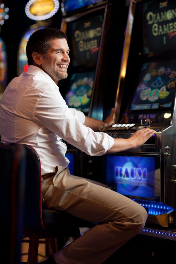 Young Man Smiling Next To the Slot Machine Stock Image - Image of ...