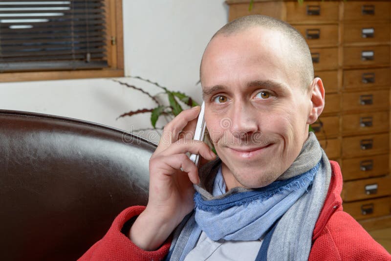 A Young Man Smiling with a Phone Stock Image - Image of casual ...