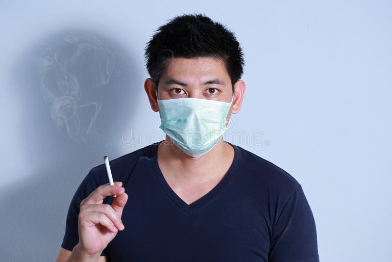 Young Man Smoking Cigarette with Protective Mask Stock Image - Image of ...