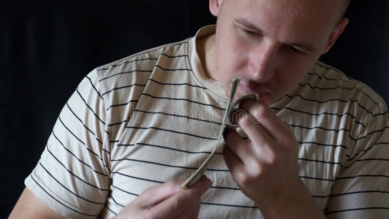 Young Man Sniffing a Hundred-dollar Bill Stock Footage - Video of ...