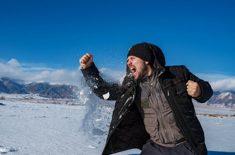 Man in the Snow Screaming on Mountains Background Stock Photo - Image ...