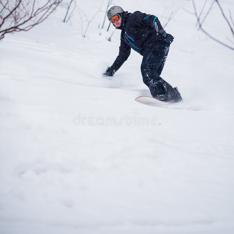 Young Man Snowboarding Down a Slope Stock Photo - Image of skiing, blue ...