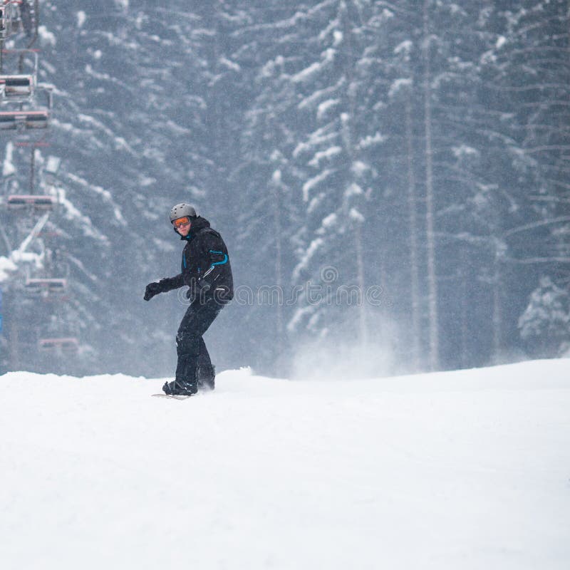Young Man Snowboarding Down a Slope Stock Photo - Image of countryside ...