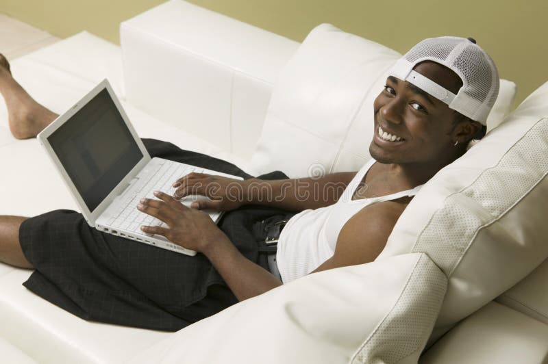 Young Man on Sofa Using Laptop High Angle View Portrait Stock Image ...