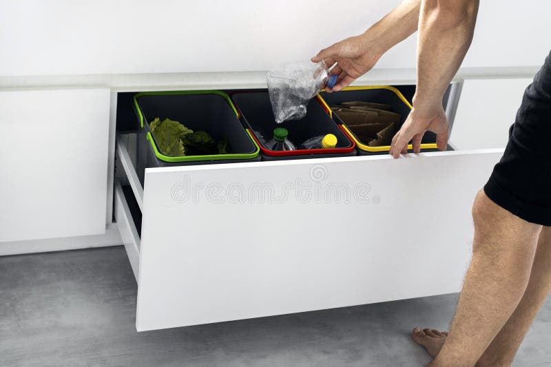 A Young Man Sorts Garbage in Containers in the Kitchen in Slow Motion ...