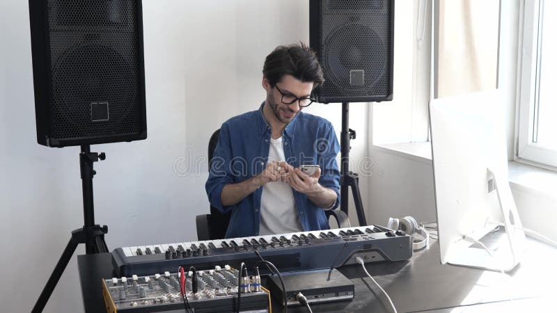 Young Man in Sound Recording Studio. Guy Sit at Keyboard and Using ...
