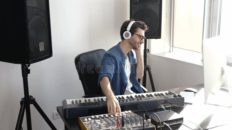 Young Man in Sound Recording Studio. Guy Sit at Table and Work with ...