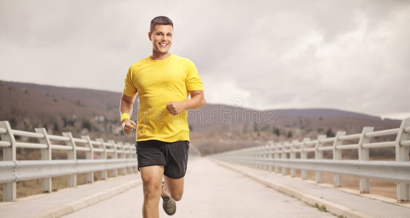 Young Man in Sportswear Running on a Bridge Stock Photo - Image of ...