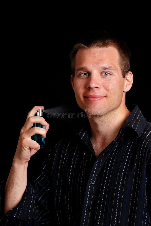 Young man spraying cologne stock photo. Image of cologne - 5700726