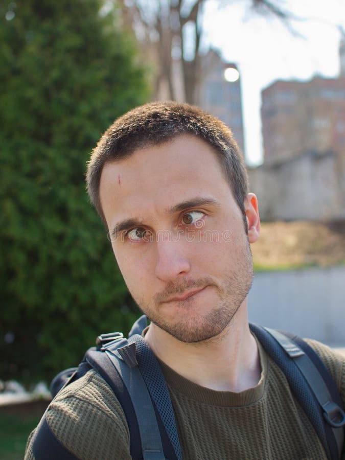 A Young Man with Squinted Eyes. Stock Photo - Image of obliquely, ride ...
