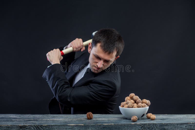 Young man stabs a nut stock image. Image of pile, crack - 54498409