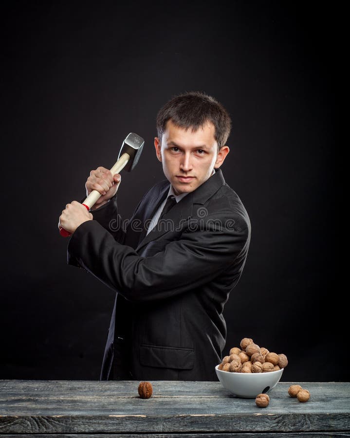 Young man stabs a nut stock image. Image of pile, crack - 54498409