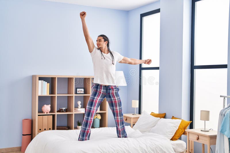 Young Man Standing on Bed Dancing at Bedroom Stock Image - Image of ...