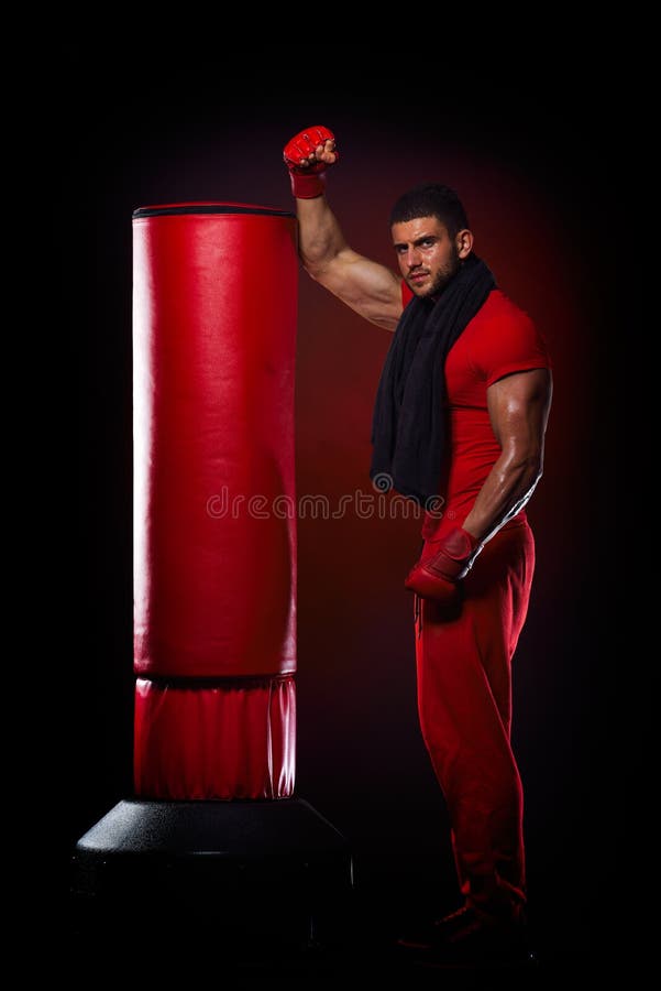 Young Man Standing by Boxing Bag Stock Image - Image of confident ...
