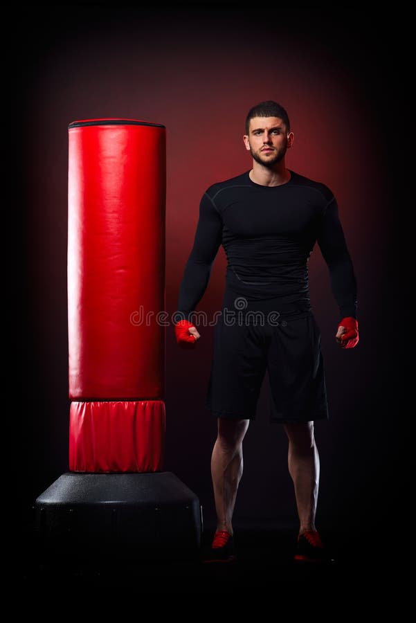 Young Man Standing by Boxing Bag in Studio Stock Image - Image of ...