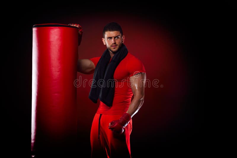 Young Man Standing by Boxing Bag in Studio Stock Photo - Image of ...