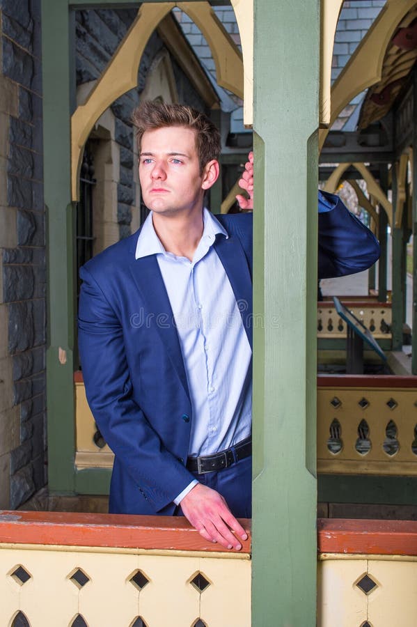 Young Man Standing by a Column at a Cottage, Looking Forward Stock ...