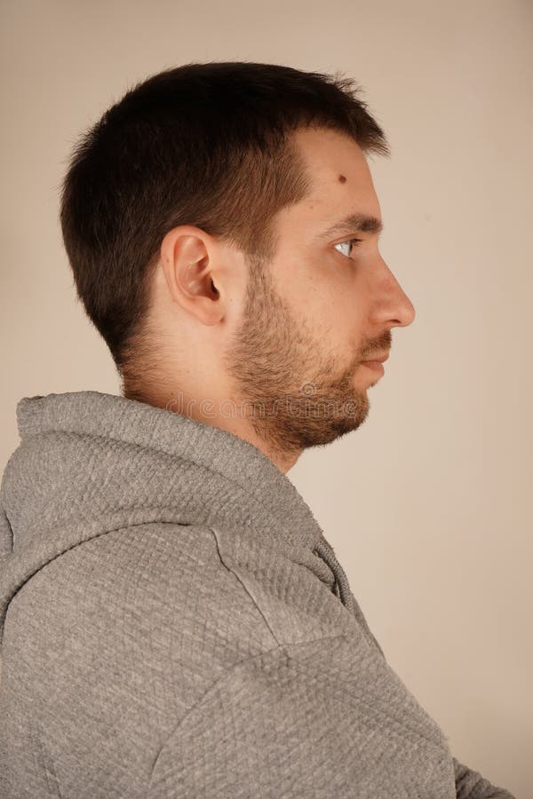 Young Man Standing in Front of Camera. Human Looking at Side. Crossed ...