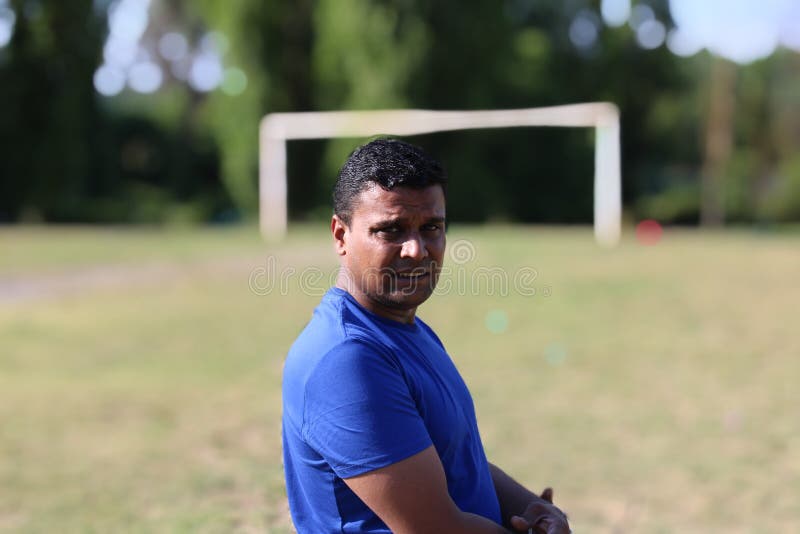 Young Man Standing in Front of Football Goal Post in Determined Style ...