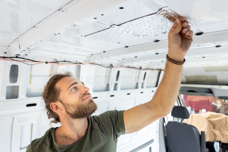 Man Puts Noise Insulation on the Inside of a Van Stock Image - Image of ...